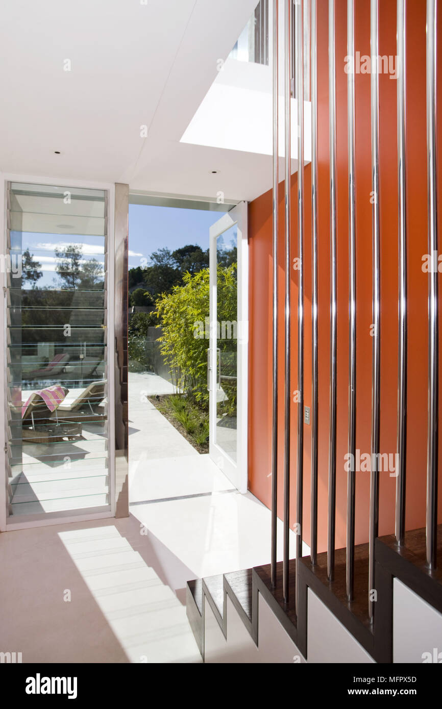 Modern hallway with view through door to garden Stock Photo - Alamy