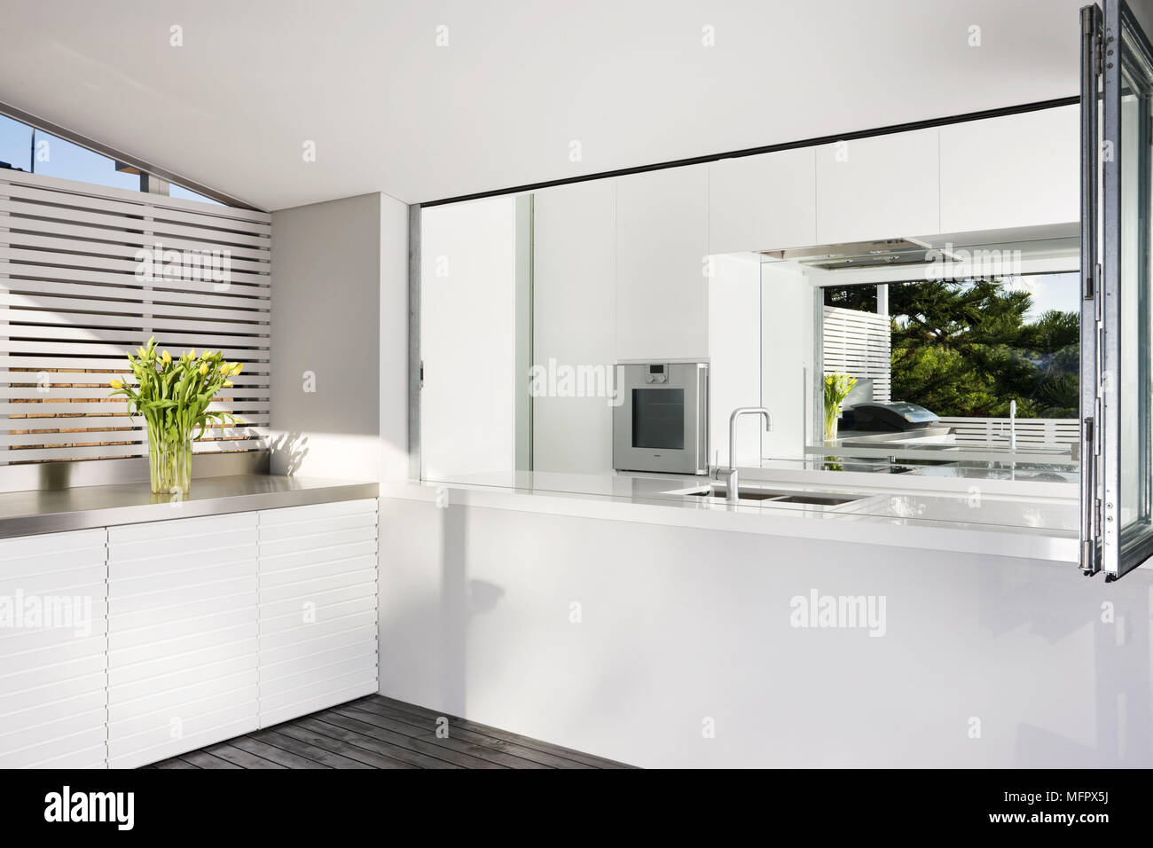 Modern kitchen with white fitted units Stock Photo - Alamy