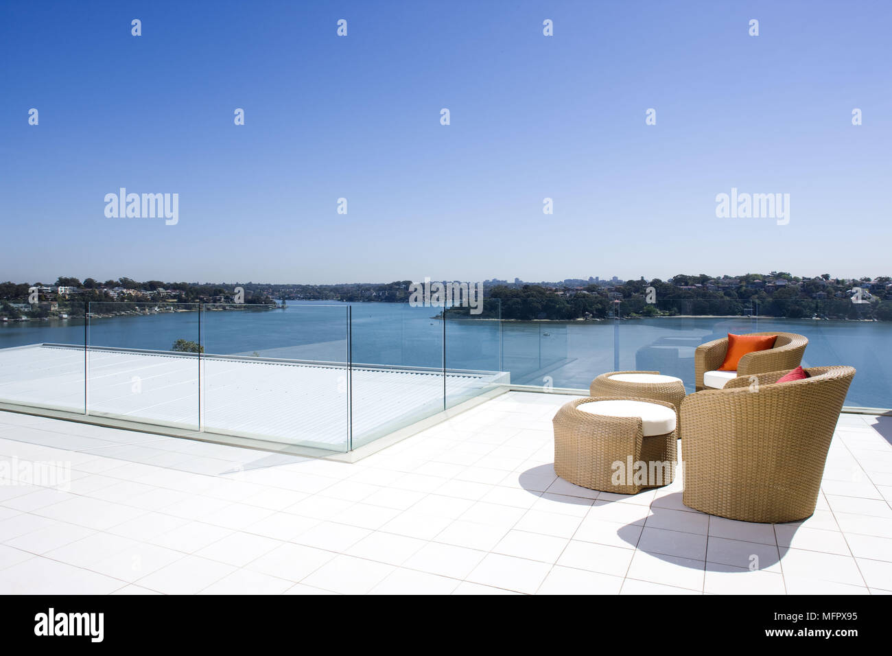 Seating on paved terrace overlooking bay Stock Photo - Alamy