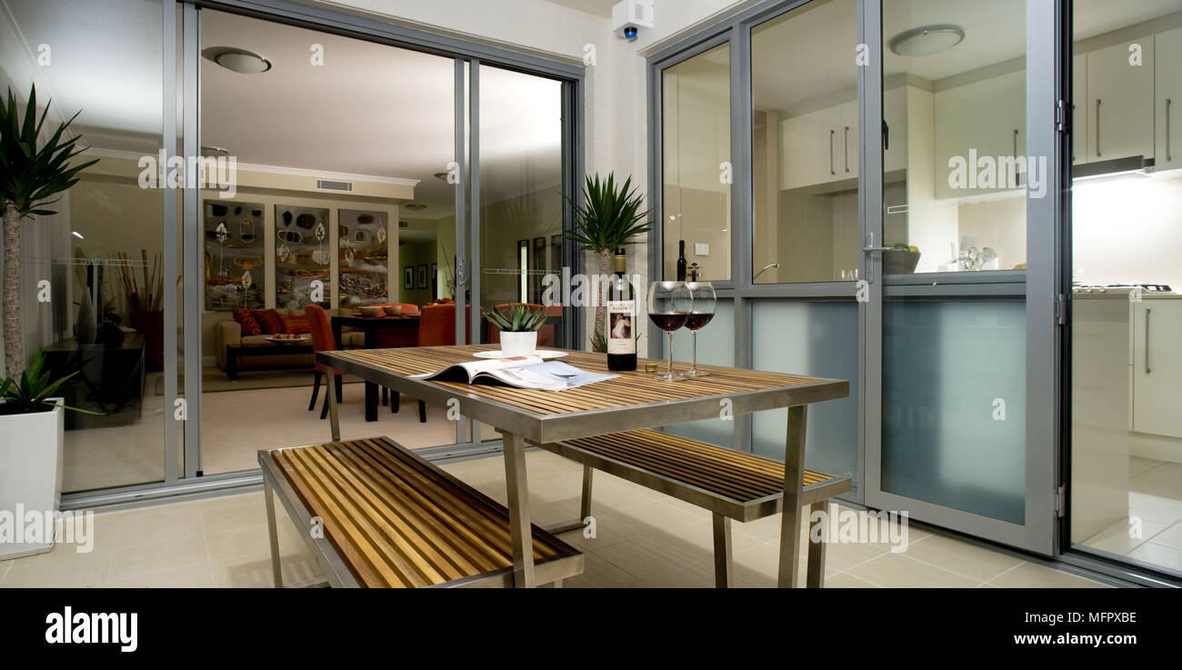 Table and bench seats on terrace courtyard Stock Photo - Alamy