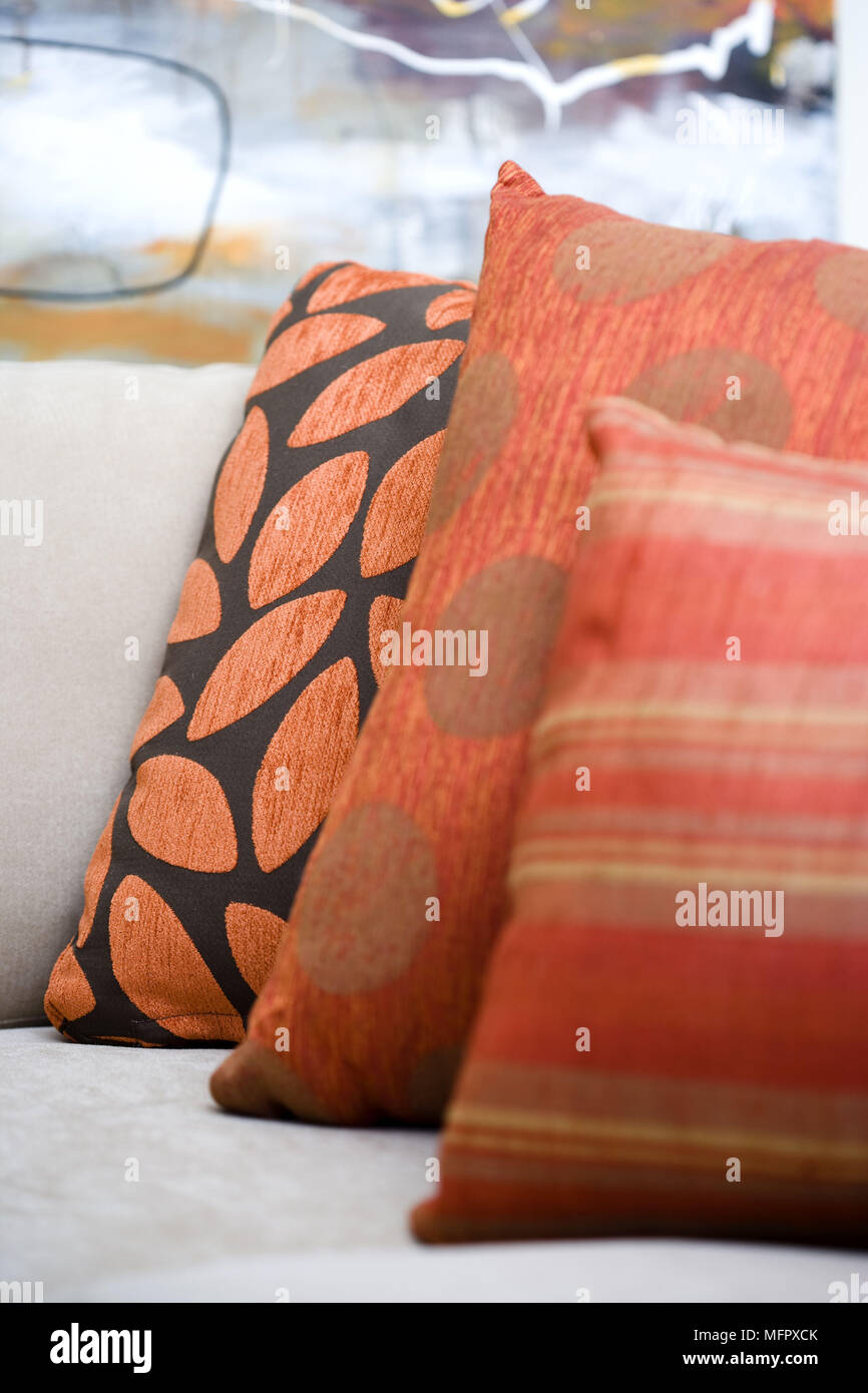 Three pattern cushions on shades of red Stock Photo - Alamy