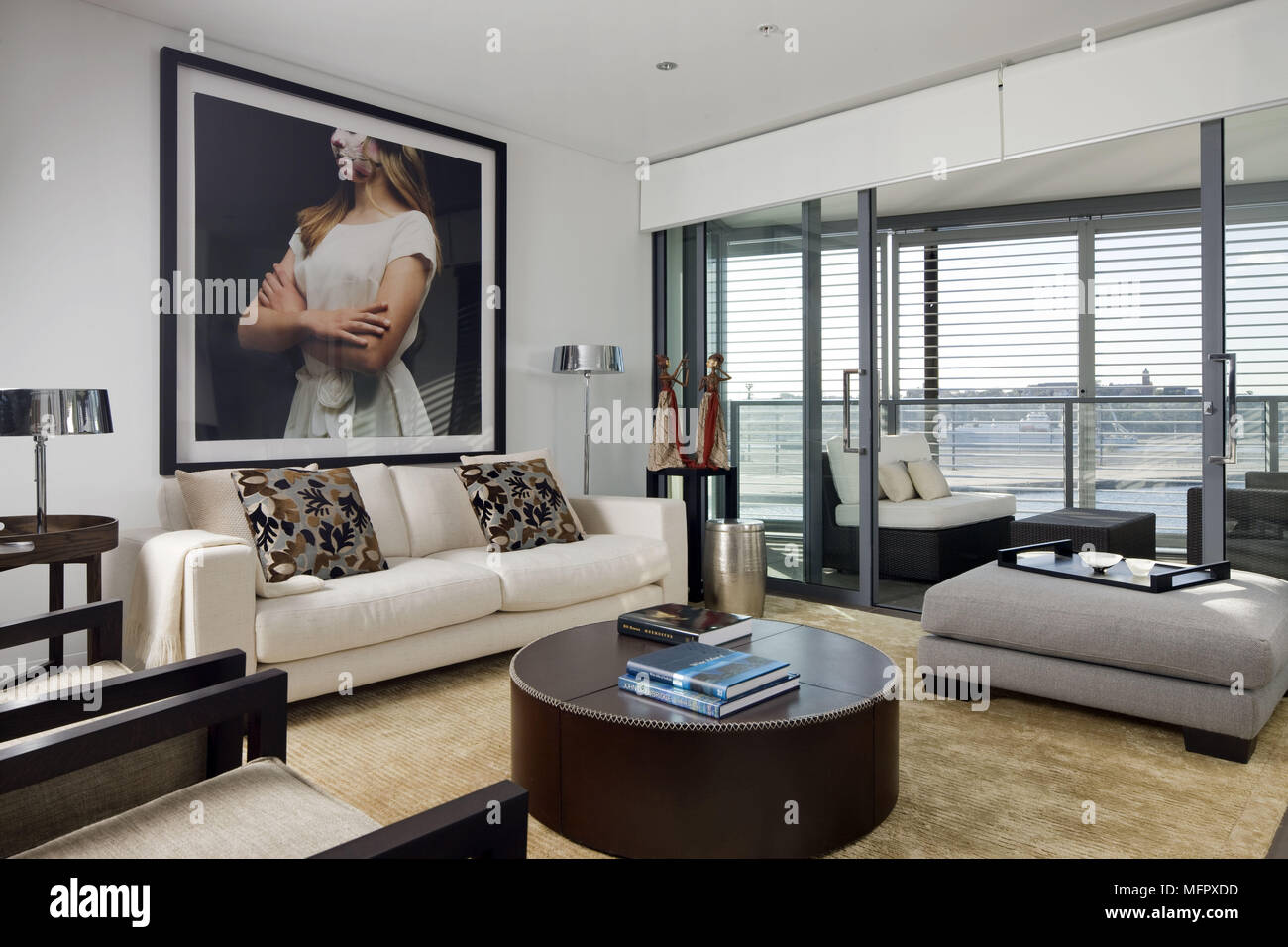 Upholstered seating around round coffee table in modern sitting room ...