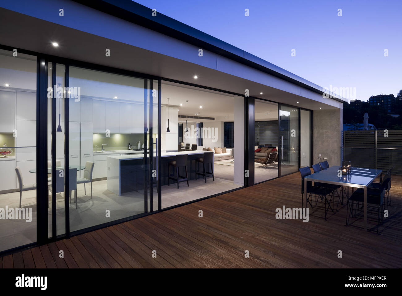 View from decked terrace into modern open plan room Stock Photo - Alamy