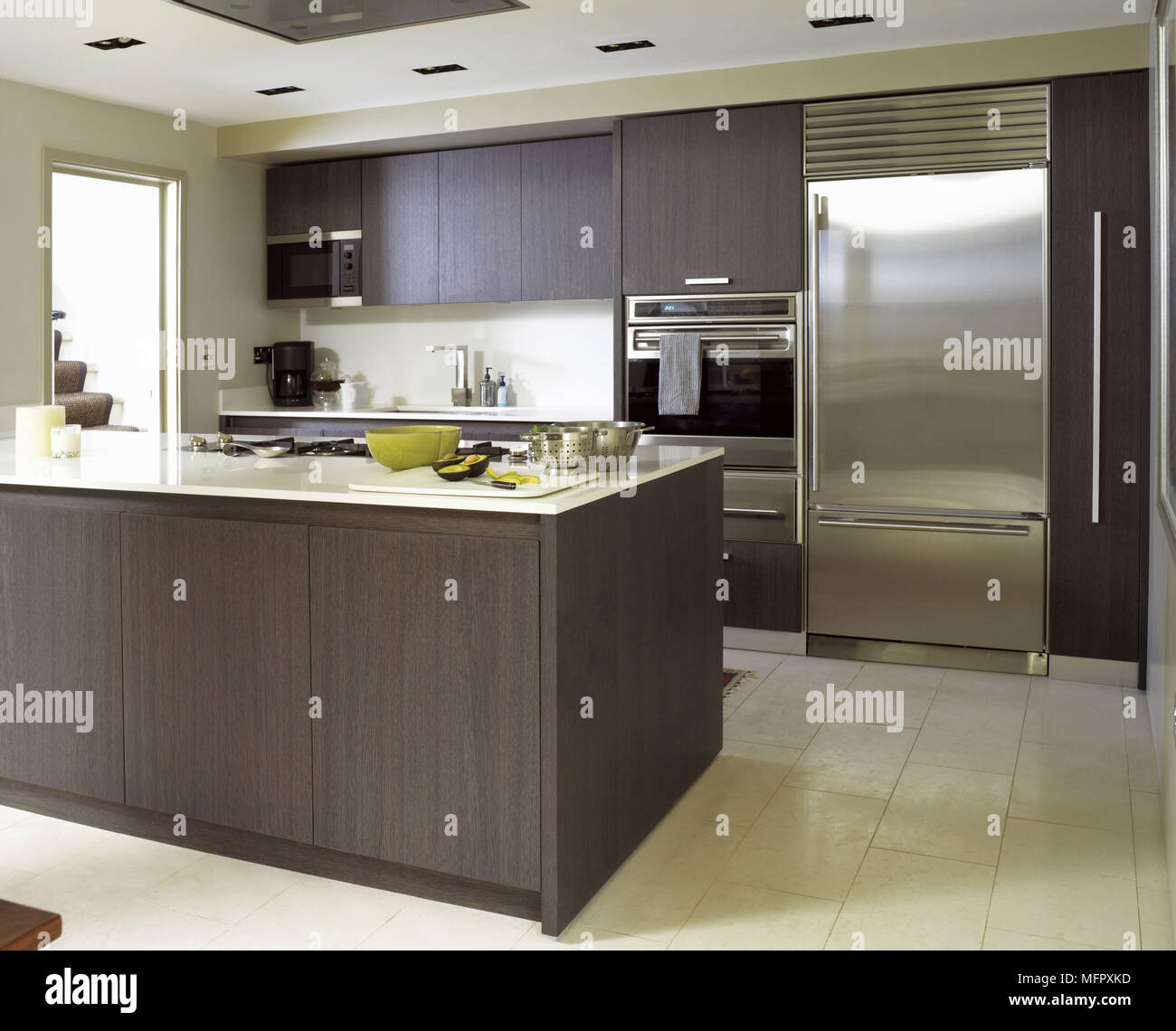 Central island unit in spacious kitchen with wood units Stock Photo - Alamy