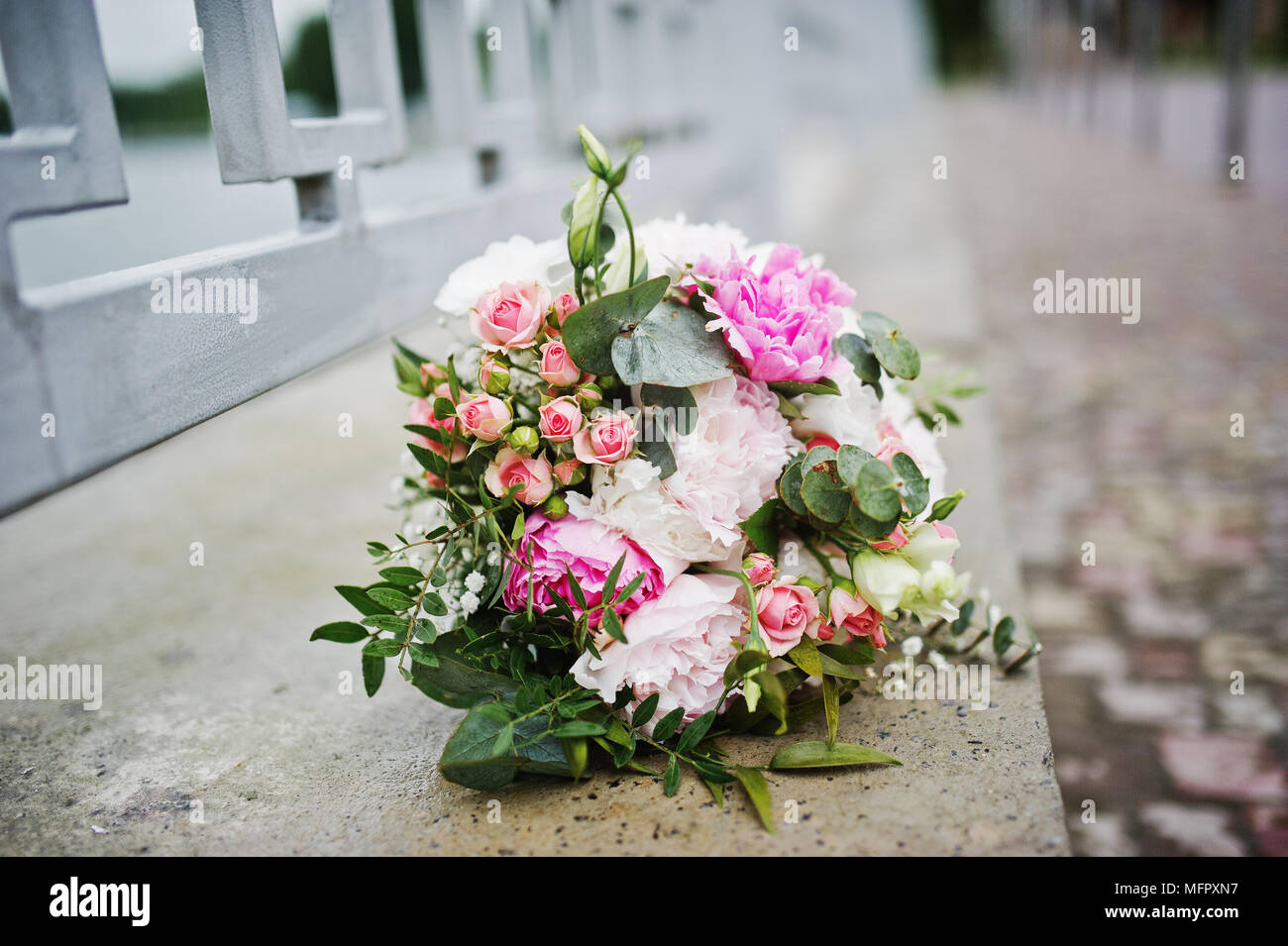 Wedding beautiful rose bouquet on pavement Stock Photo - Alamy