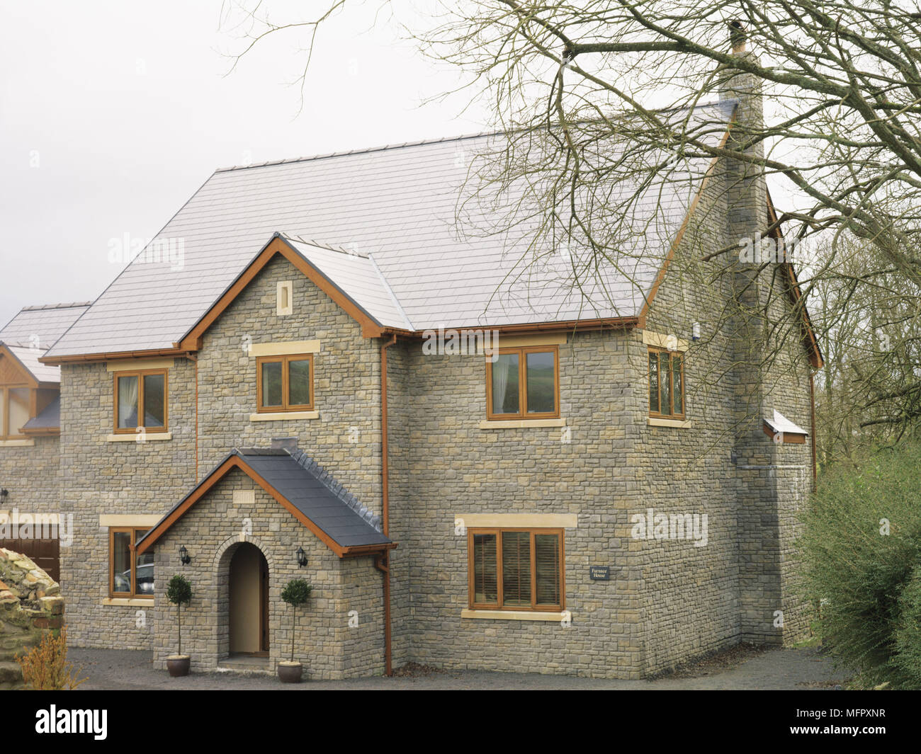 Exterior of new build stone country style house Stock Photo - Alamy