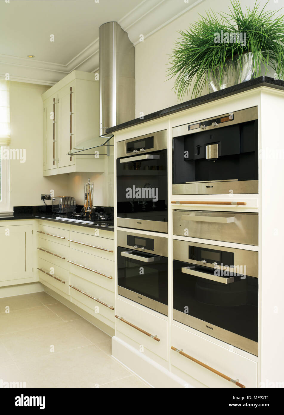 Integral ovens set in fitted units in contemporary kitchen Stock Photo ...