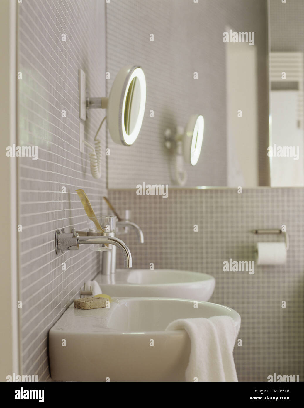 Bathroom with tiled walls and twin wash basins Stock Photo - Alamy