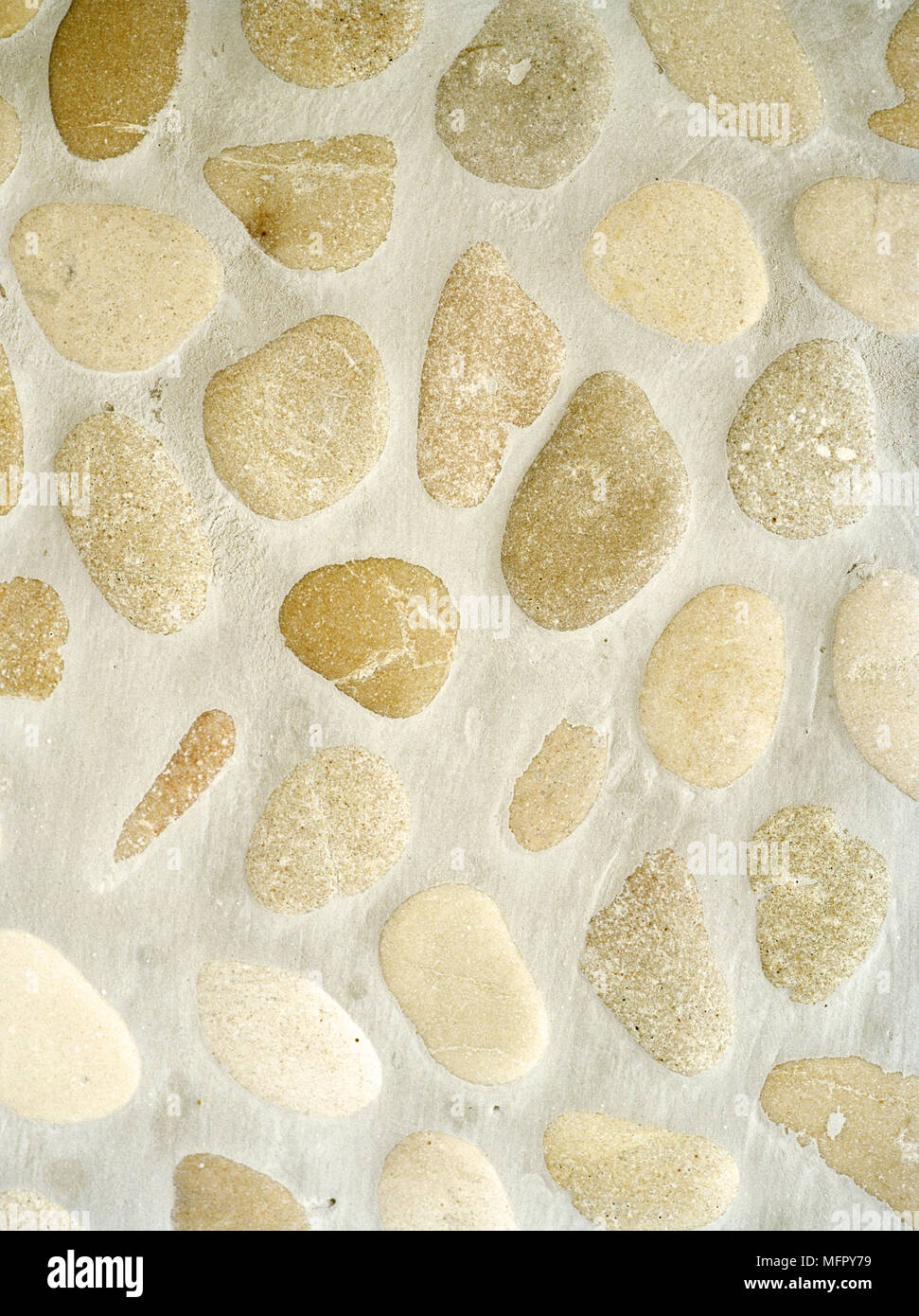 Stones set in concrete Stock Photo - Alamy