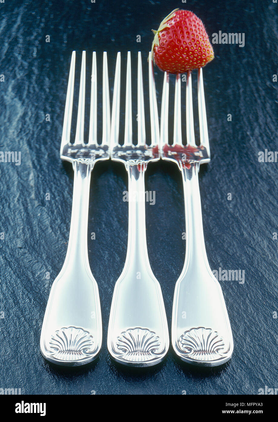 Three silver forks Stock Photo - Alamy