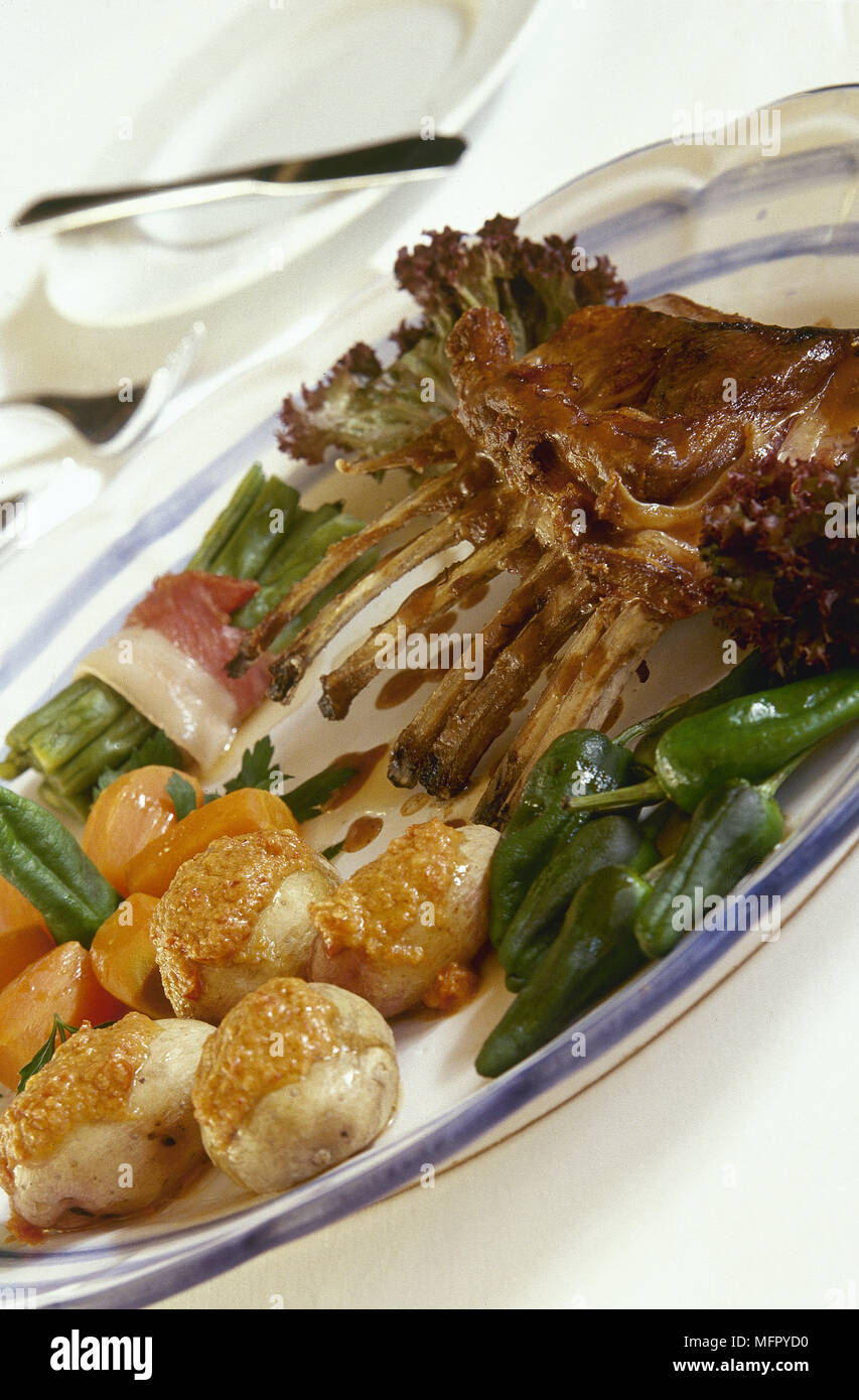 Roast rack of lamb and vegetables Stock Photo - Alamy