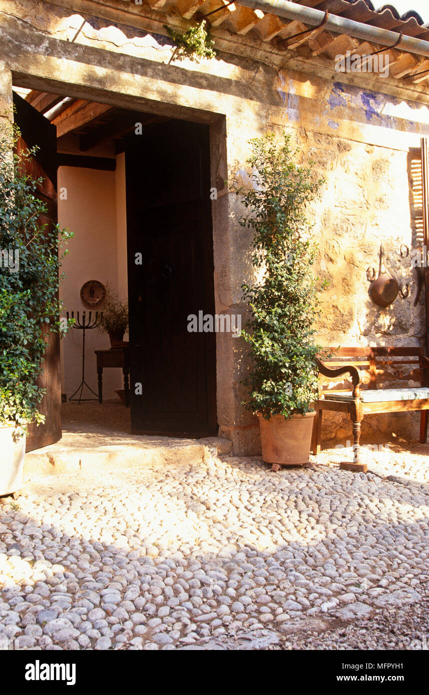 Exterior of rustic country villa with pebble courtyard Stock Photo - Alamy