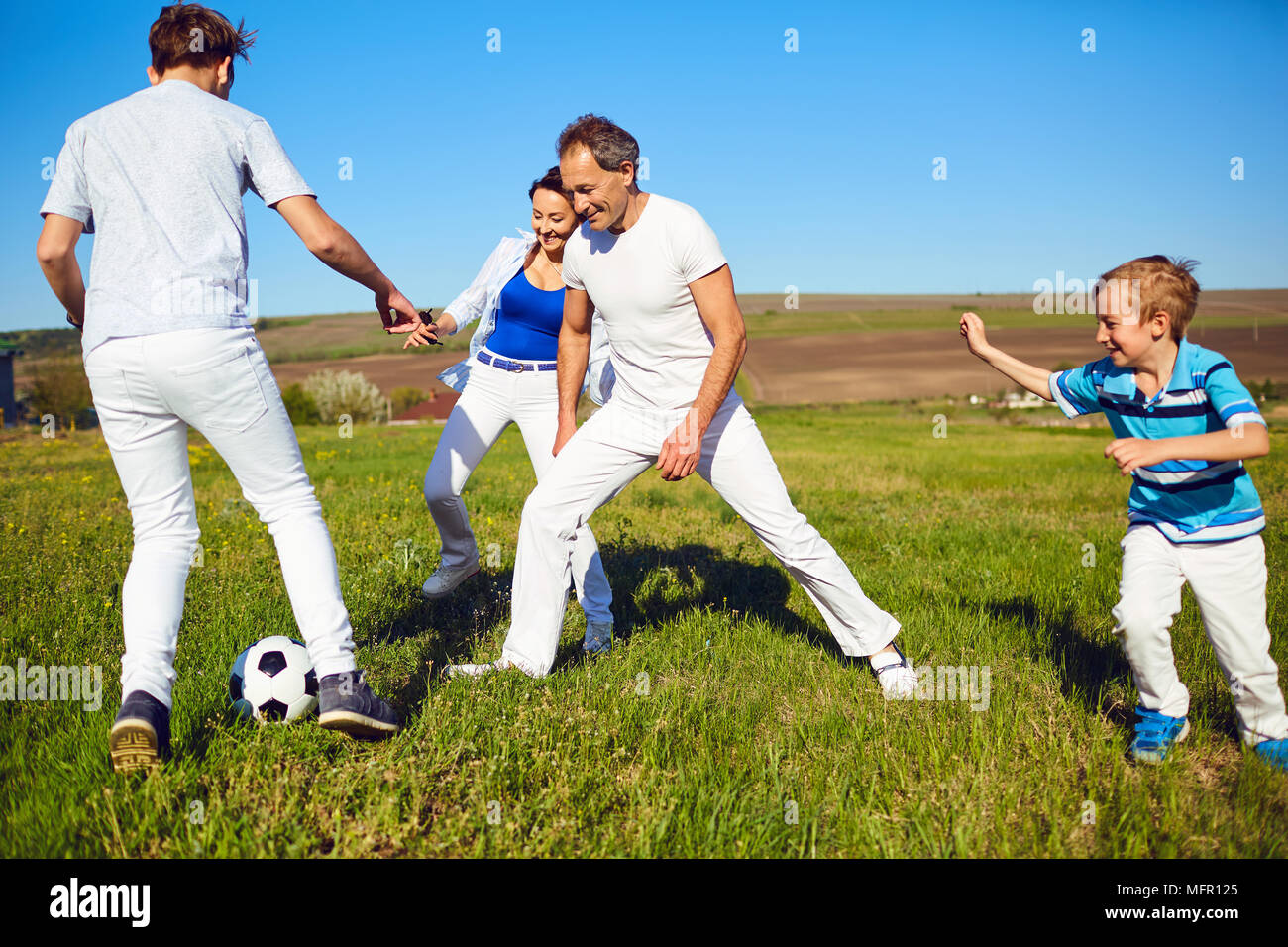 Happy family playing with a ball on nature in spring, summer Stock ...