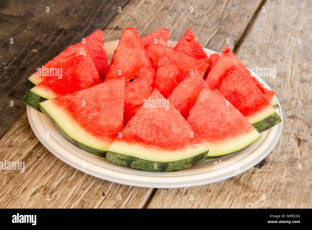 Seedless watermelon cut into wedges serving on dish Stock Photo - Alamy