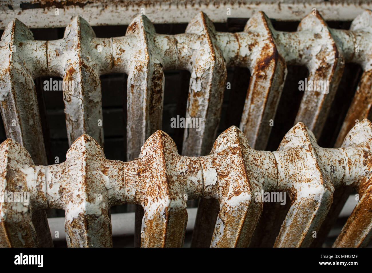 Old cast-iron battery. Vintage rusty battery section Stock Photo - Alamy