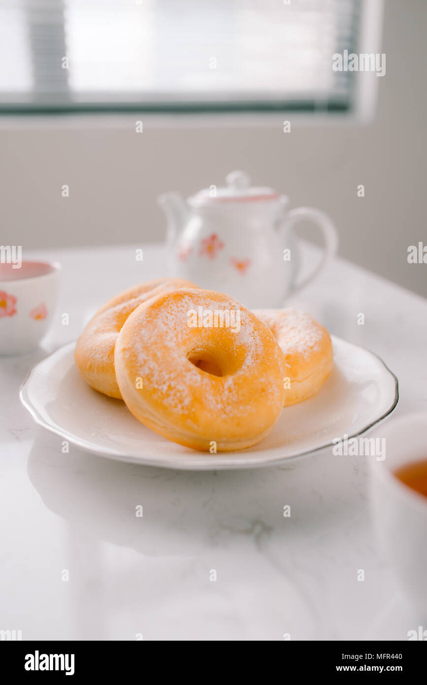 sugar donut and tea on white background Stock Photo - Alamy