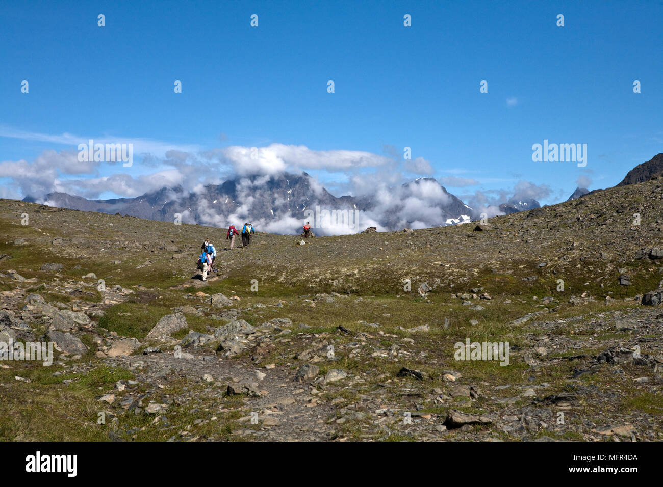 Hikers walking through Crow Pass in Alaska, which was once part of the ...