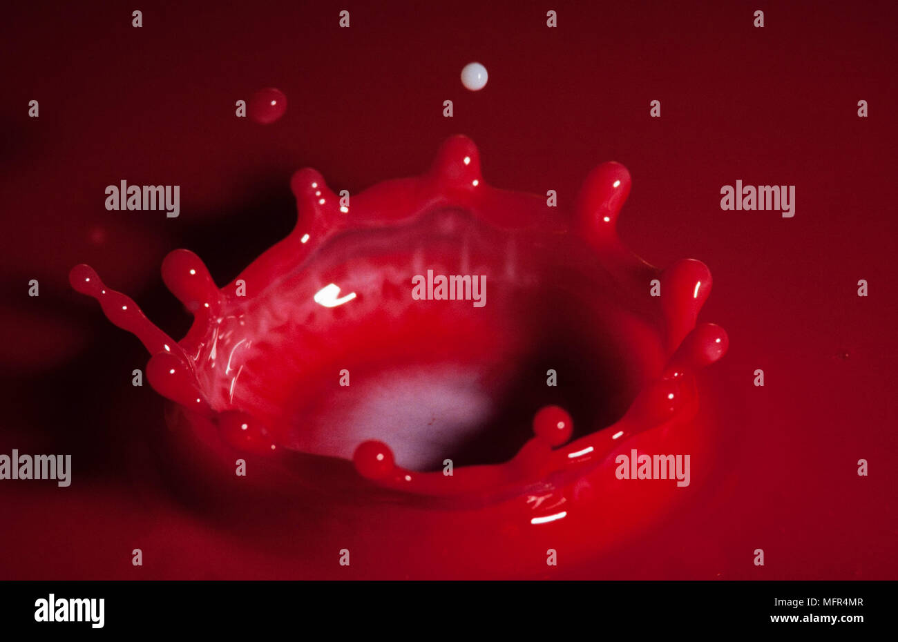 Red colored milk drop Stock Photo - Alamy