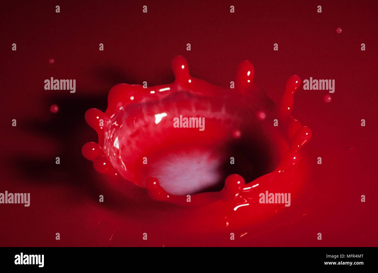 Red colored milk drop Stock Photo - Alamy