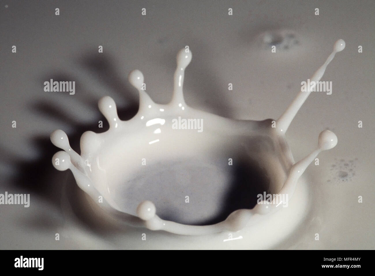 Dropping milk white liquid drops hi-res stock photography and images ...