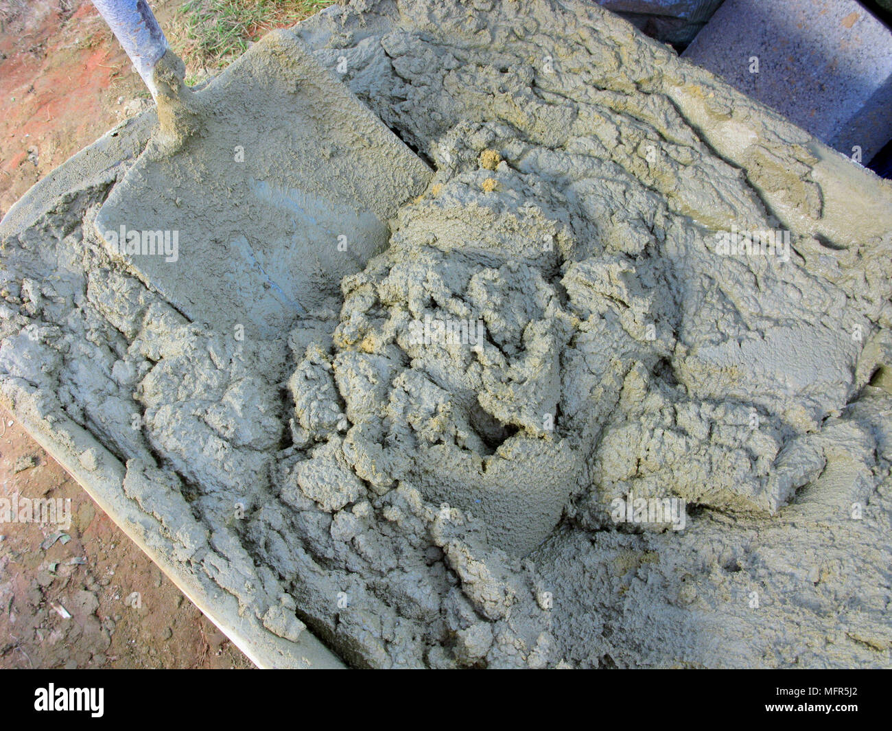Cement in a wheelbarrow ready for use Stock Photo - Alamy