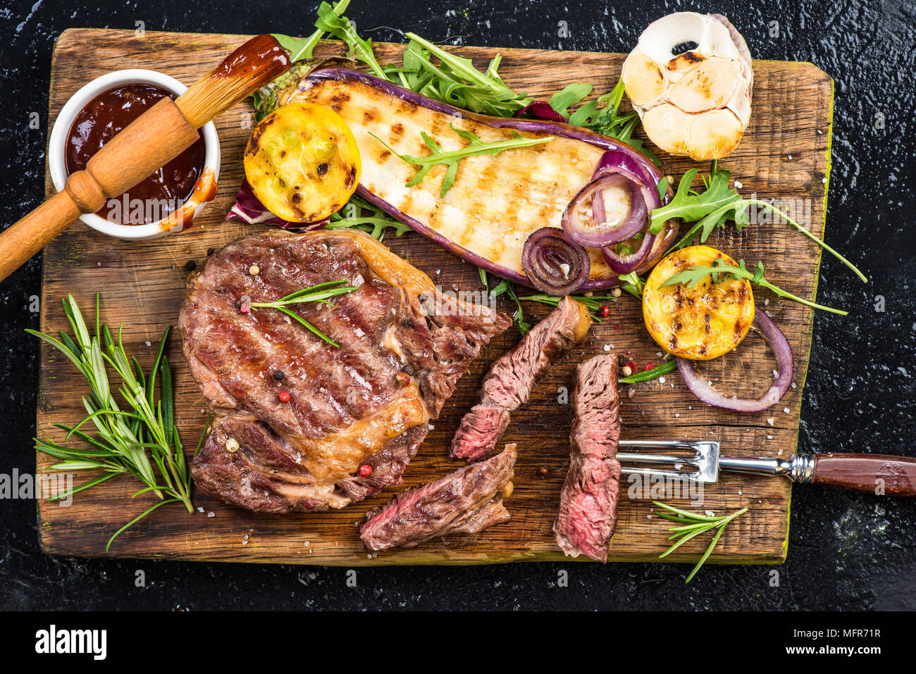 Medium rare steak grilled, top view on board Stock Photo - Alamy