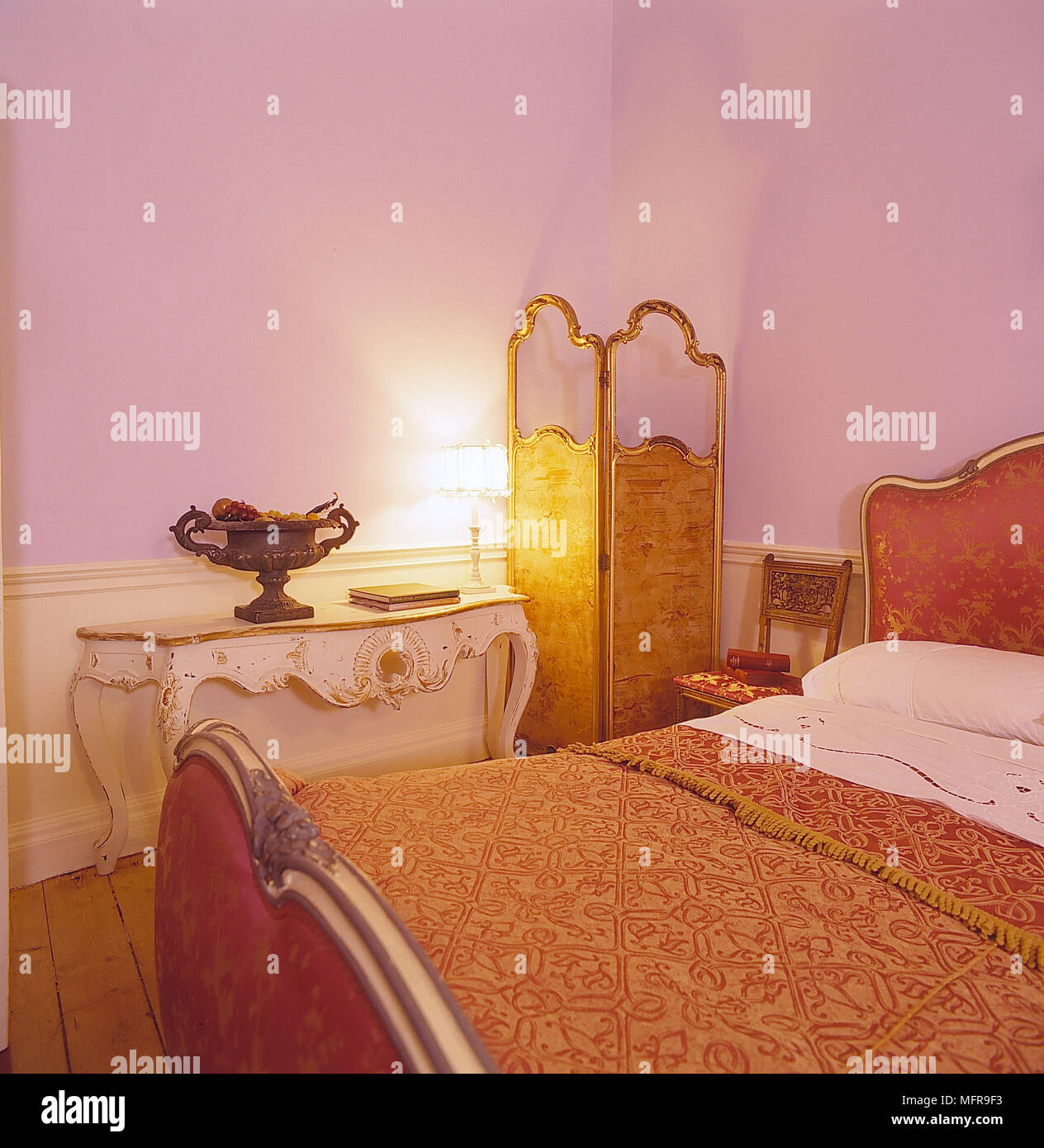 Bedroom detail lilac walls cream panelling stripped floorboards bed red ...