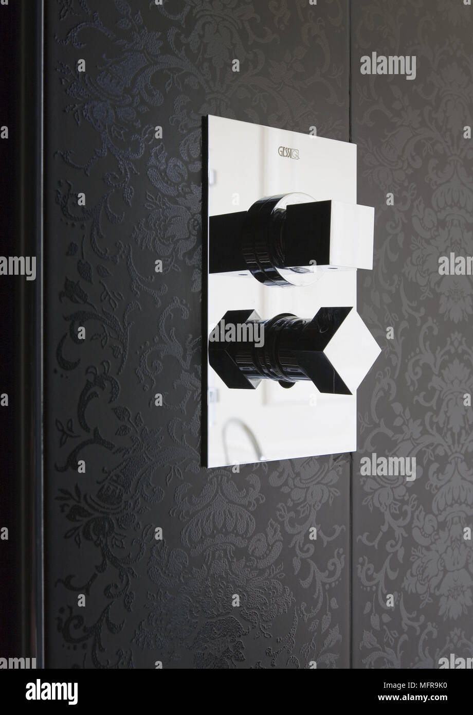 Contemporary lighting controls on wallpapered wall Stock Photo - Alamy