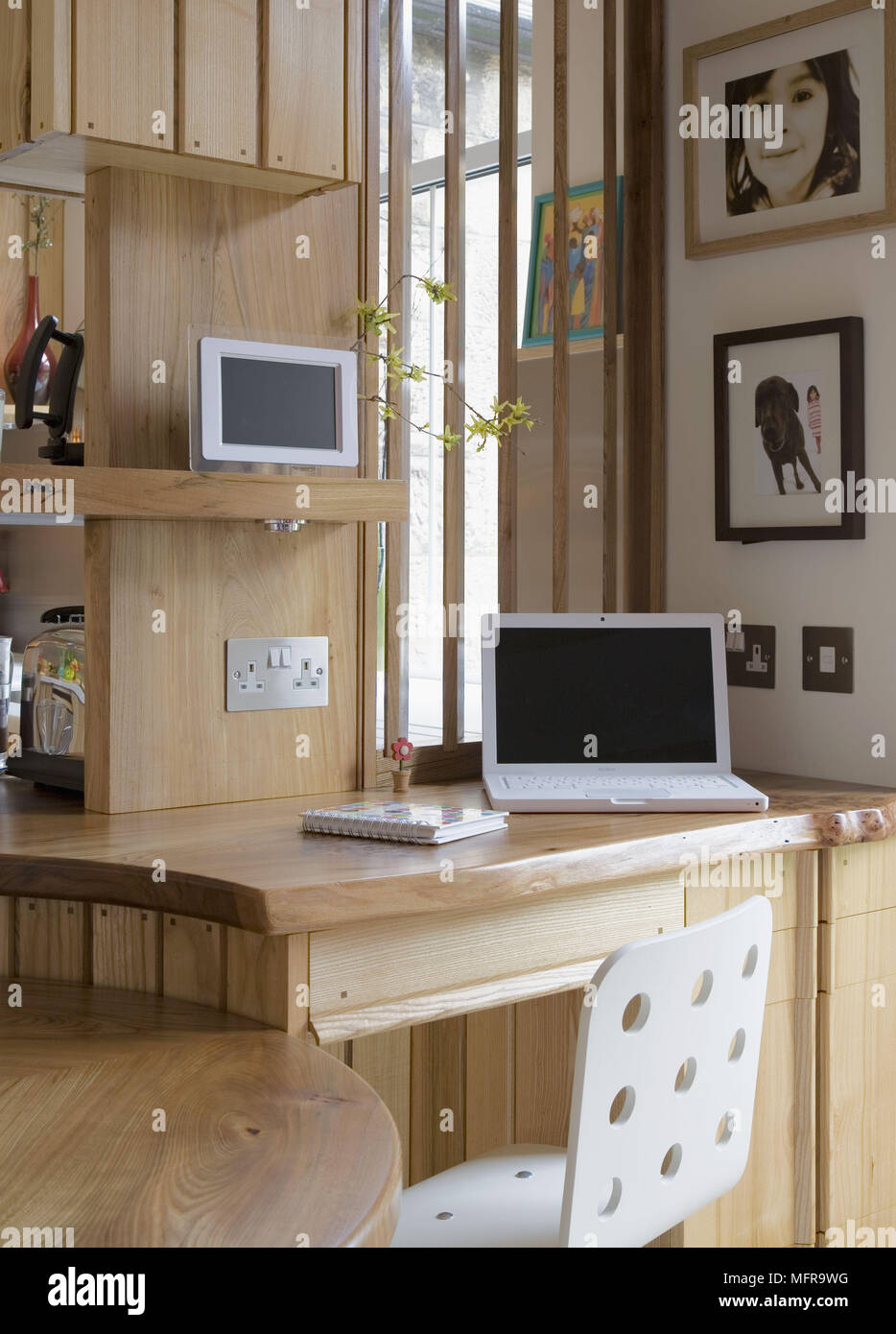 Laptop computer on wooden desk in corner of room Stock Photo - Alamy