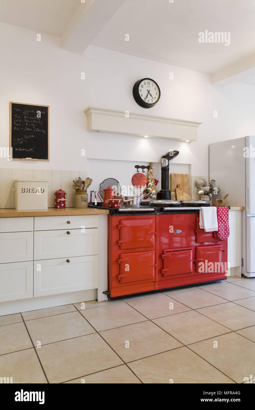 Red range oven in country style kitchen with tiled floor Stock Photo ...