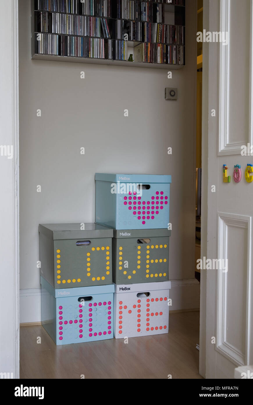 Storage boxes stacked in cupboard space Stock Photo - Alamy