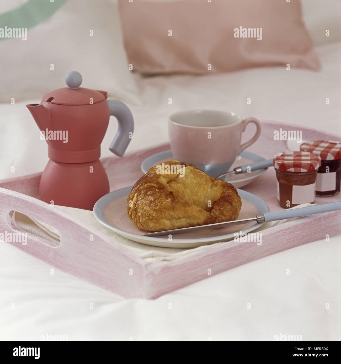 Pink breakfast tray on bed with croissant and coffee Stock Photo - Alamy