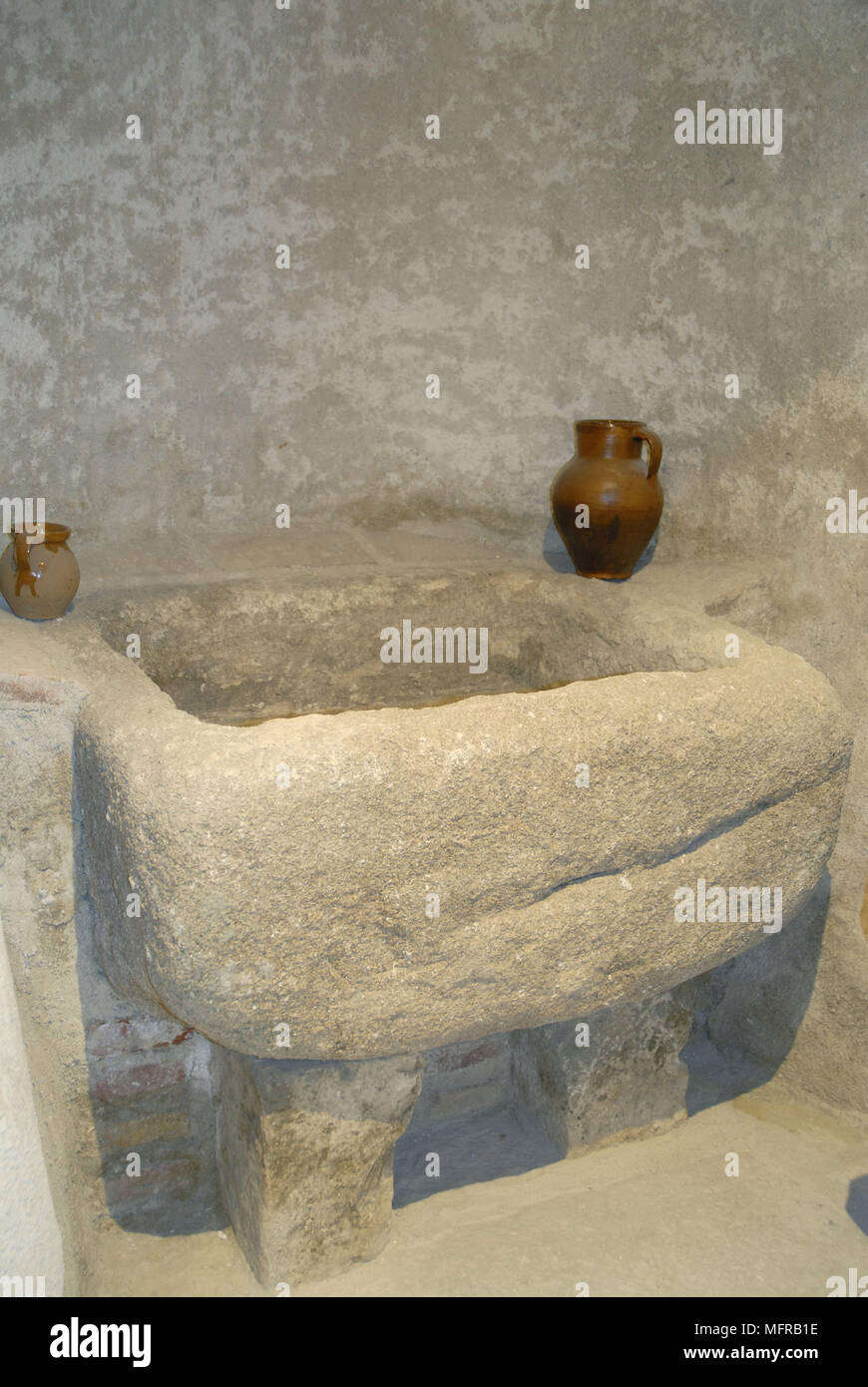 Rustic stone basin with pots Stock Photo - Alamy