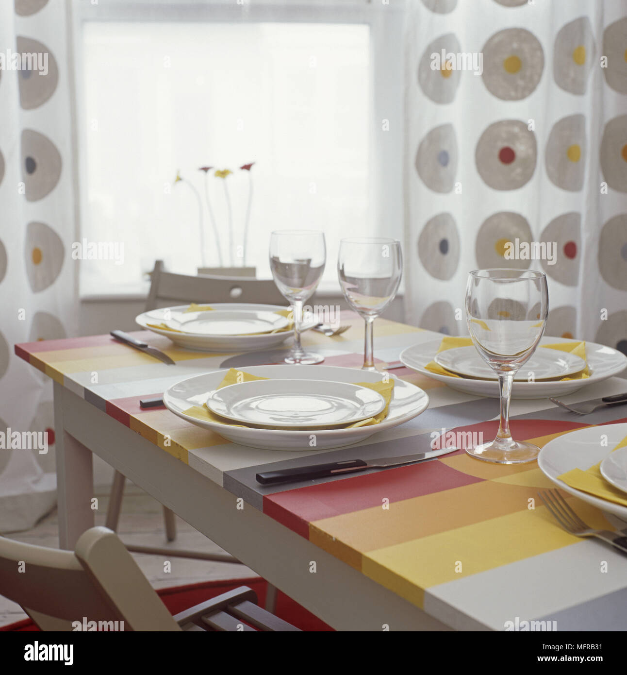 Striped table set for four in window with patterned curtain Stock Photo ...