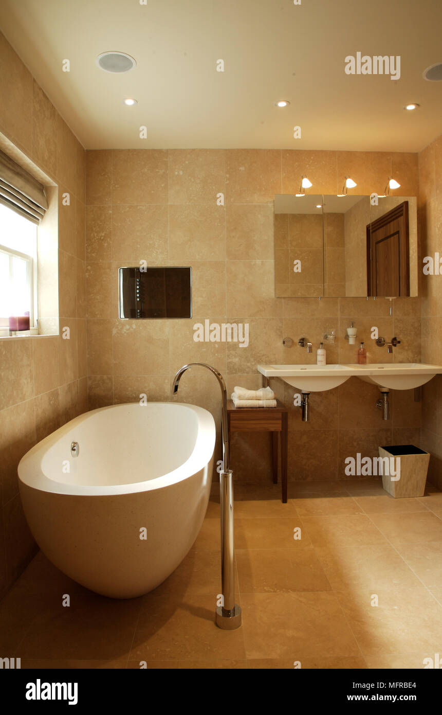 Minimalist oval bath with separate tap Stock Photo - Alamy