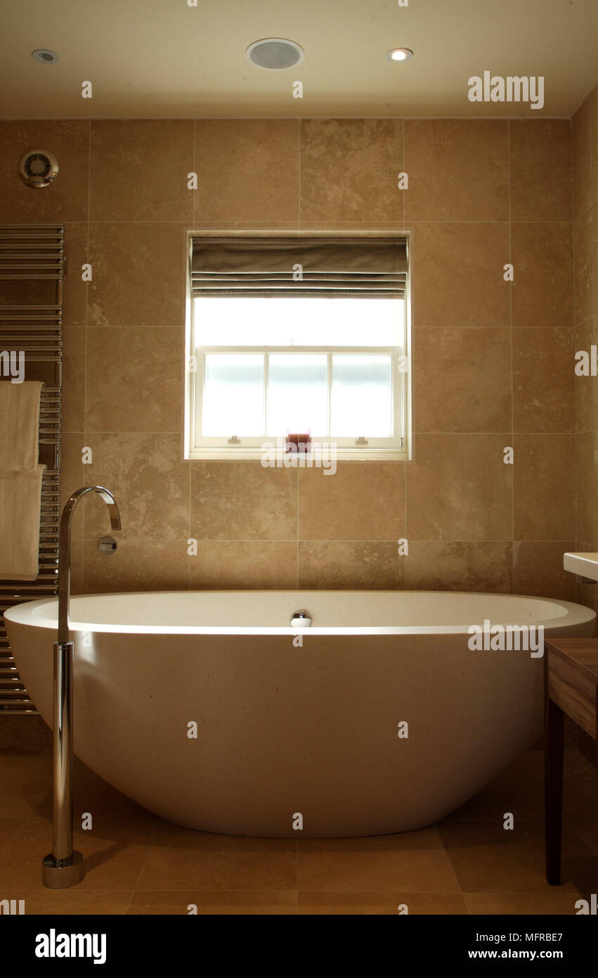 Minimalist oval bath with separate tap Stock Photo - Alamy