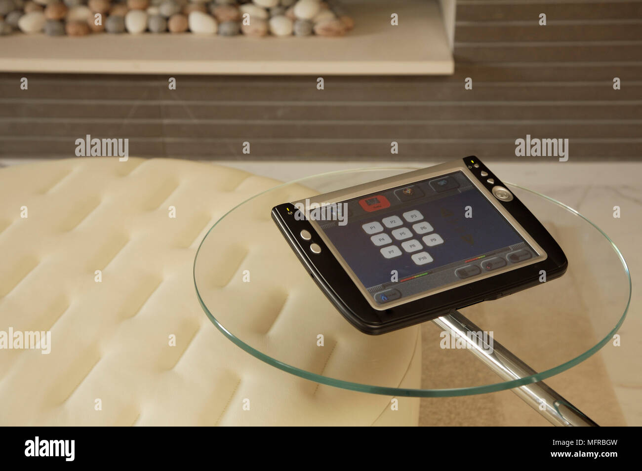 Entertainment system control pad on glass table Stock Photo - Alamy