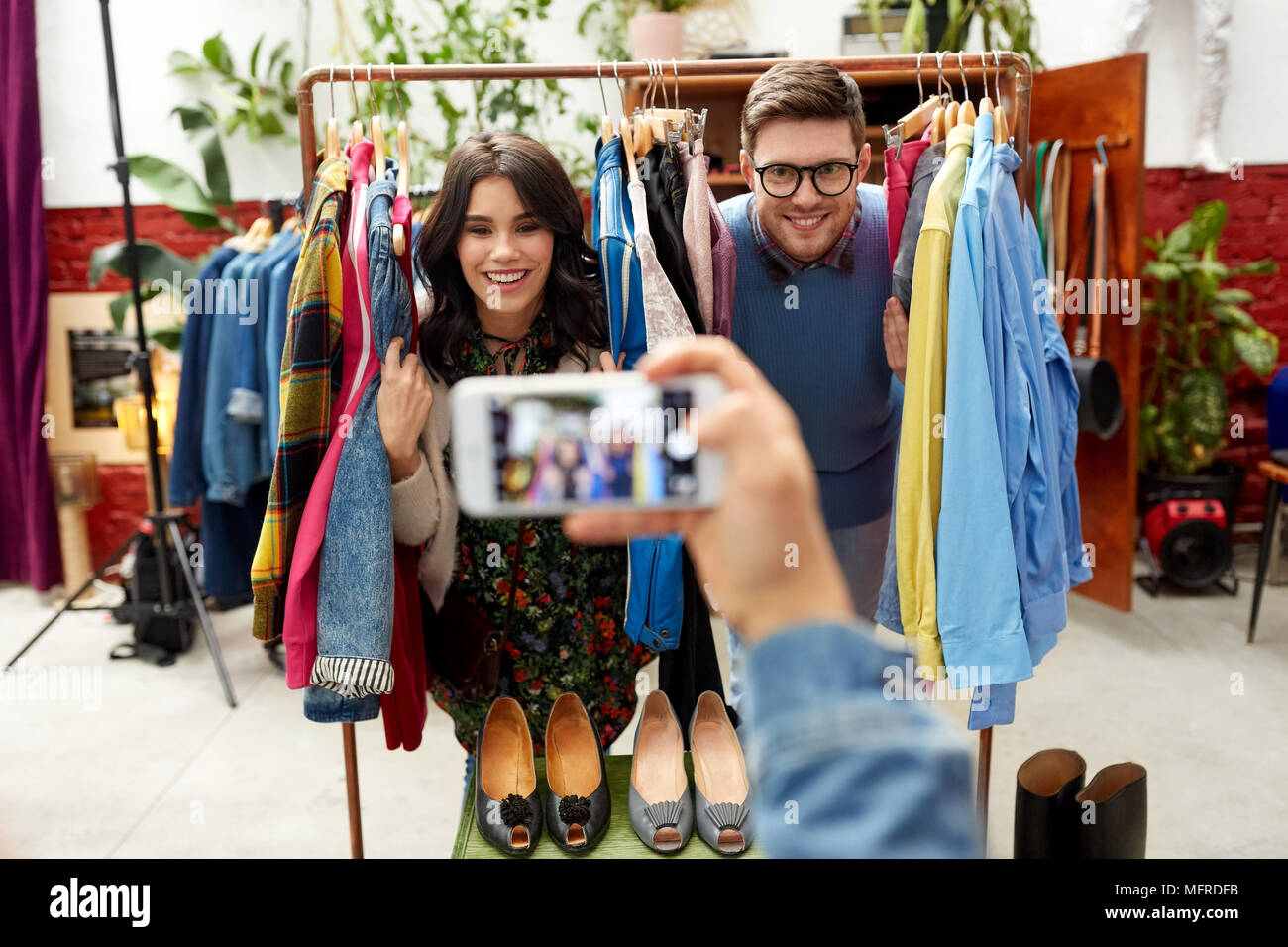 friend photographing couple at clothing store Stock Photo - Alamy