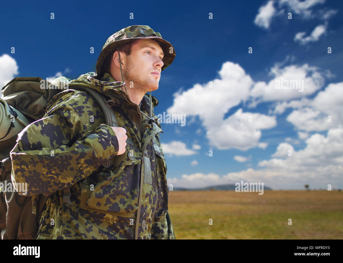 soldier in military uniform with backpack hiking Stock Photo - Alamy