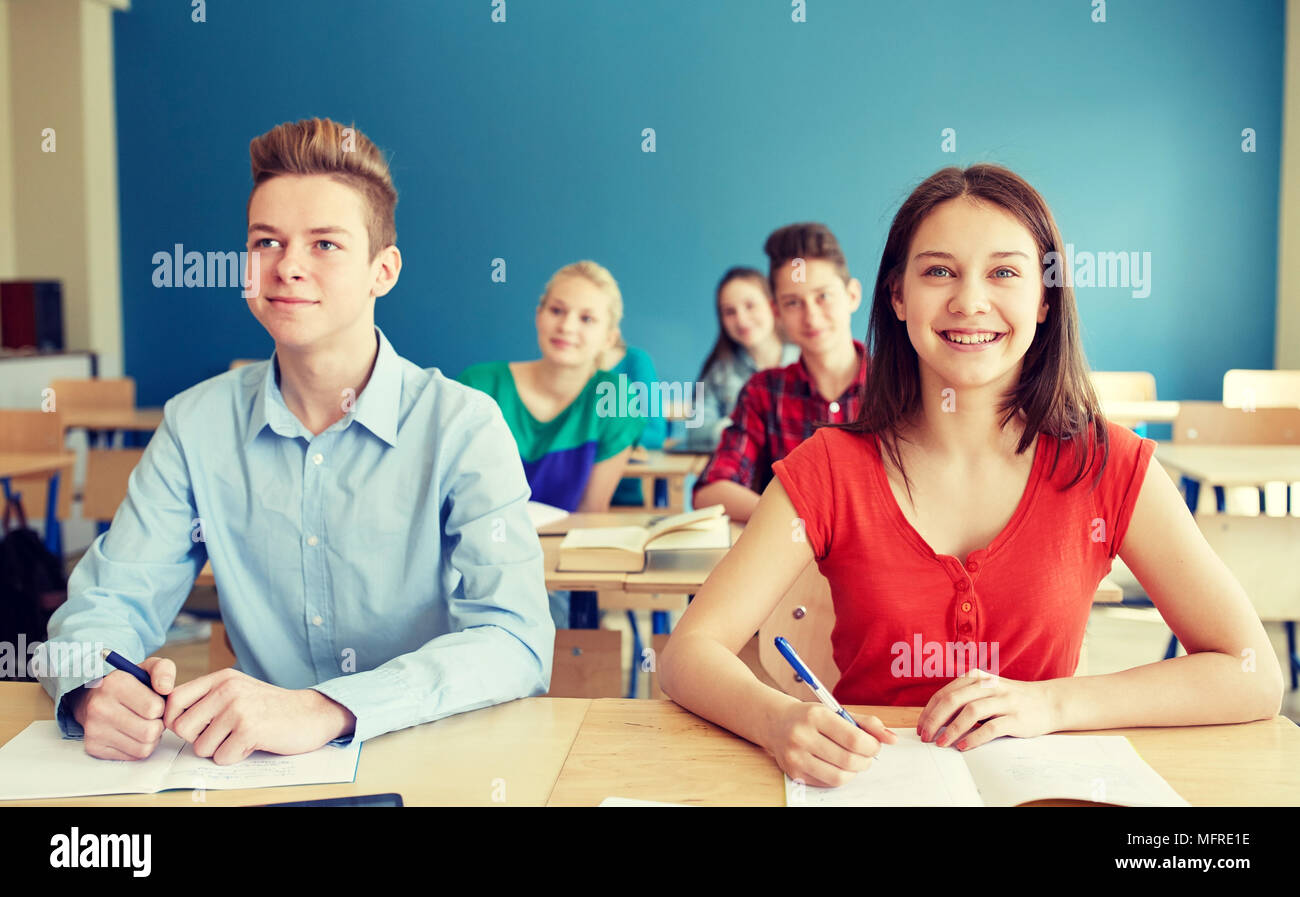happy students with notebooks at school Stock Photo - Alamy