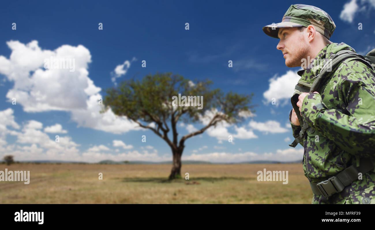 soldier in military uniform with backpack hiking Stock Photo - Alamy