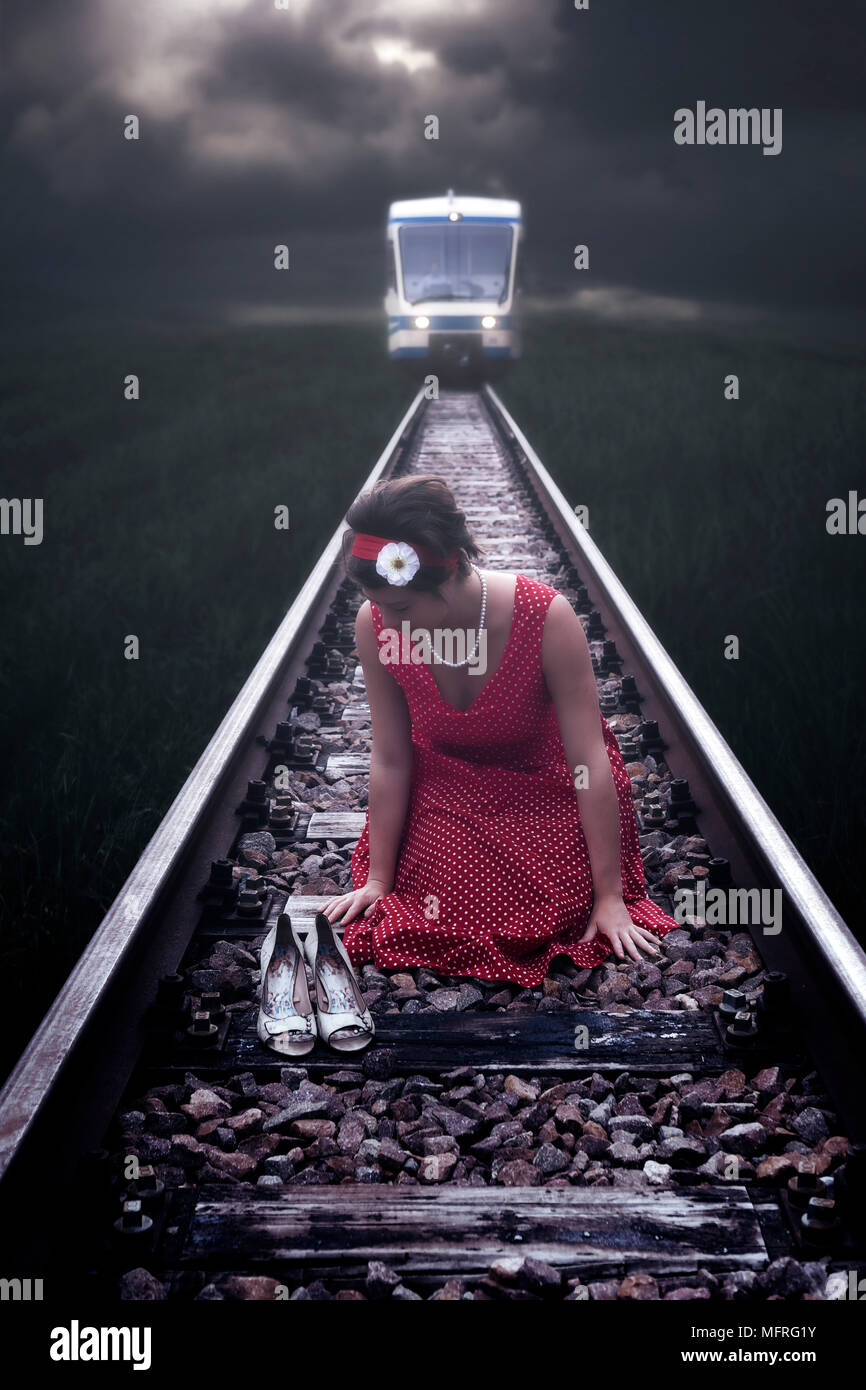 Woman sitting on a railway track hi-res stock photography and images ...