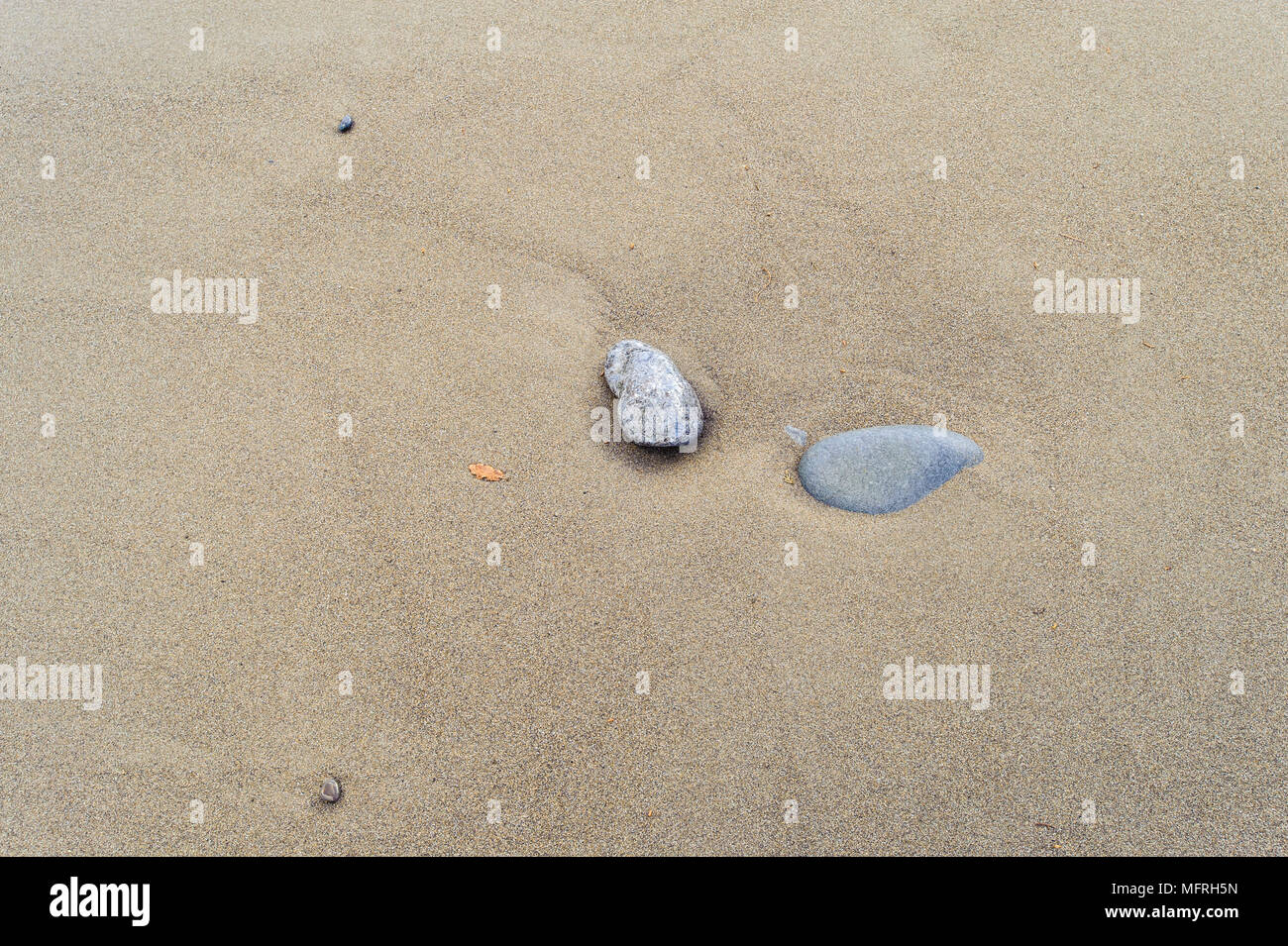 Stones on the sand Stock Photo - Alamy