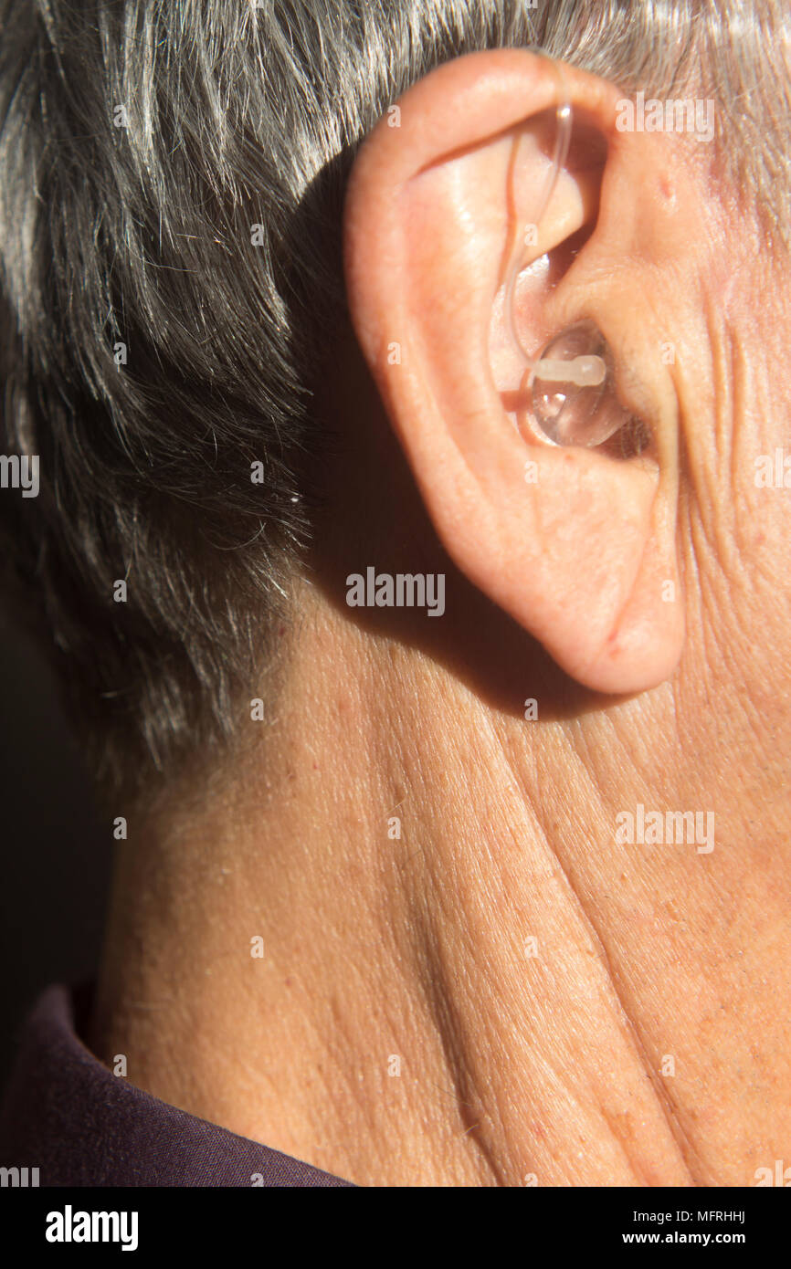 Digital modern hearing aid in the ear of aged old man Stock Photo - Alamy