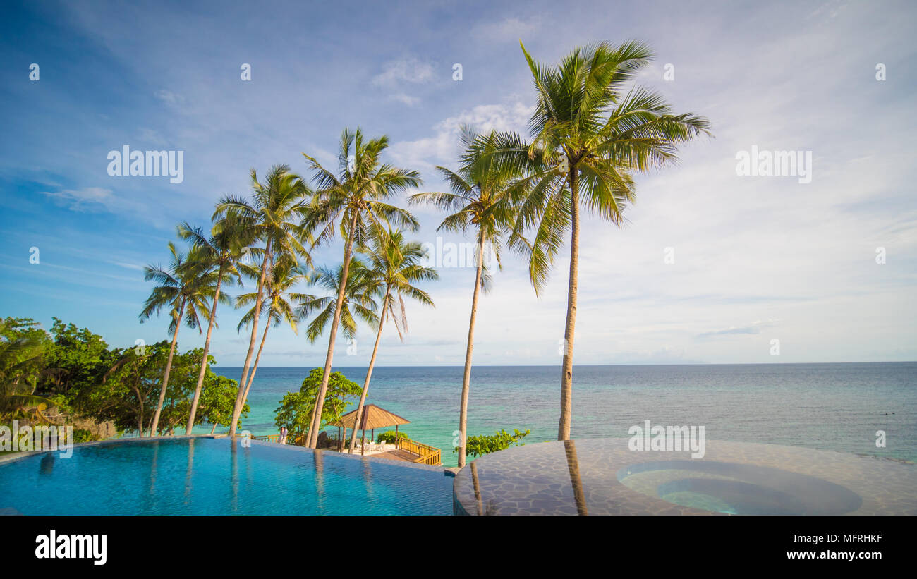 Outdoor swimming pool in a tropical country Philippines with palm trees ...