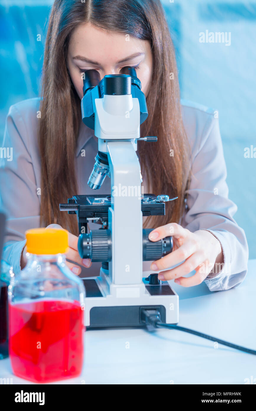Girl student with microscope in the laboratory Stock Photo - Alamy