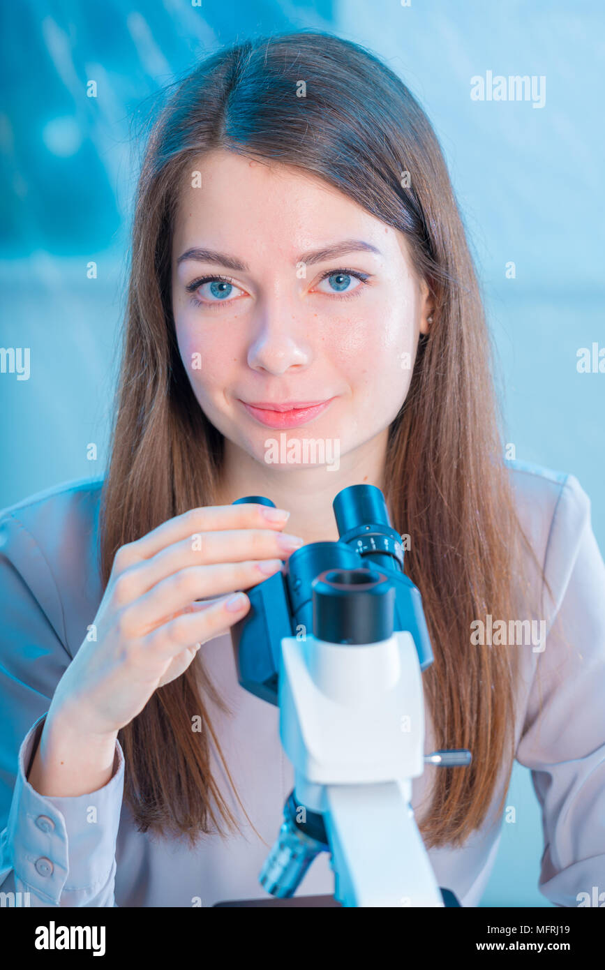 Female technician with a microscope in the laboratory Stock Photo - Alamy
