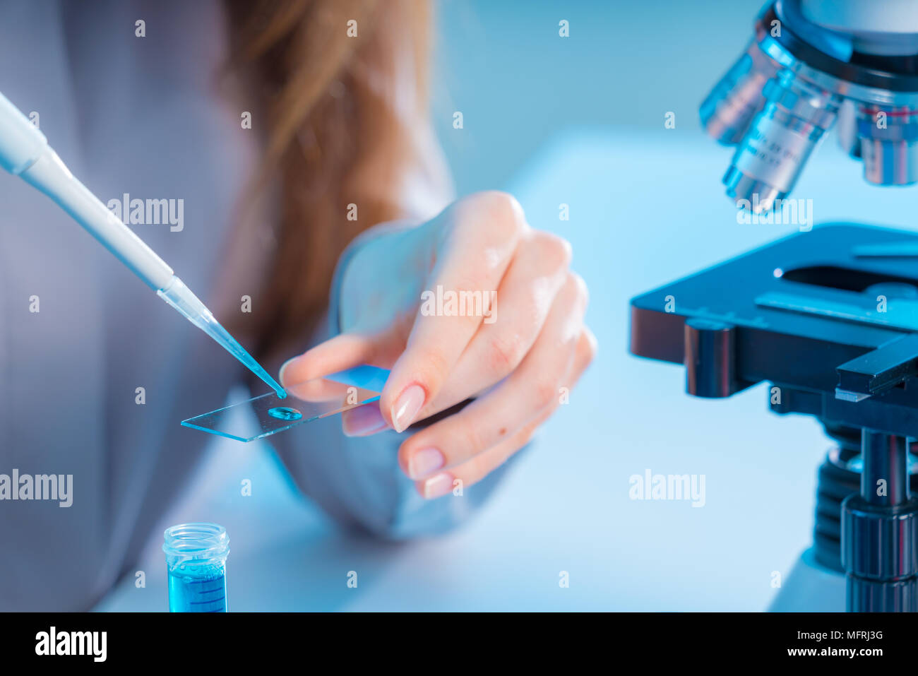 female technician take sample on microscope slide Stock Photo - Alamy