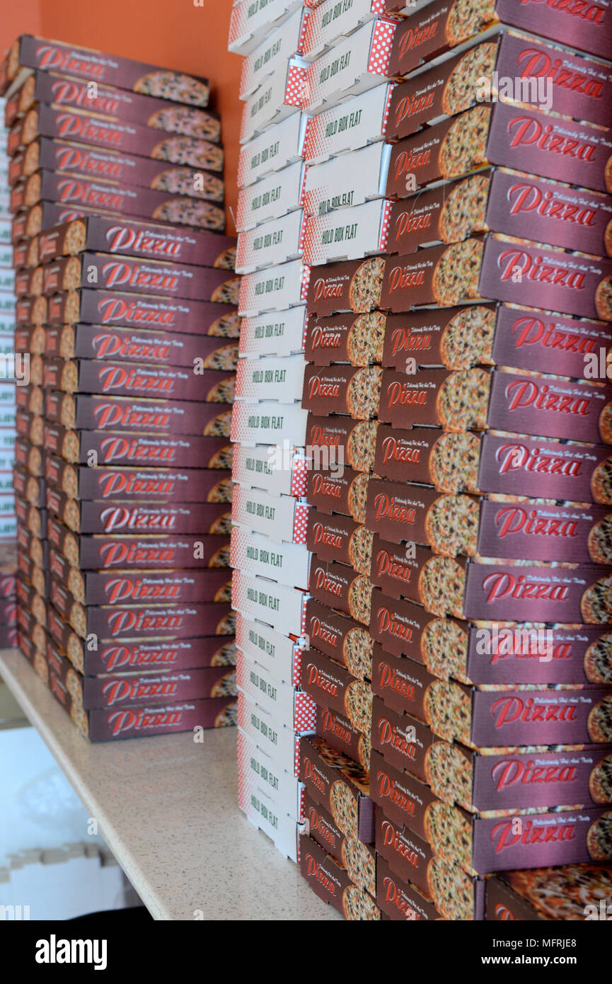 A tower of pizza boxes in a takeaway Stock Photo - Alamy