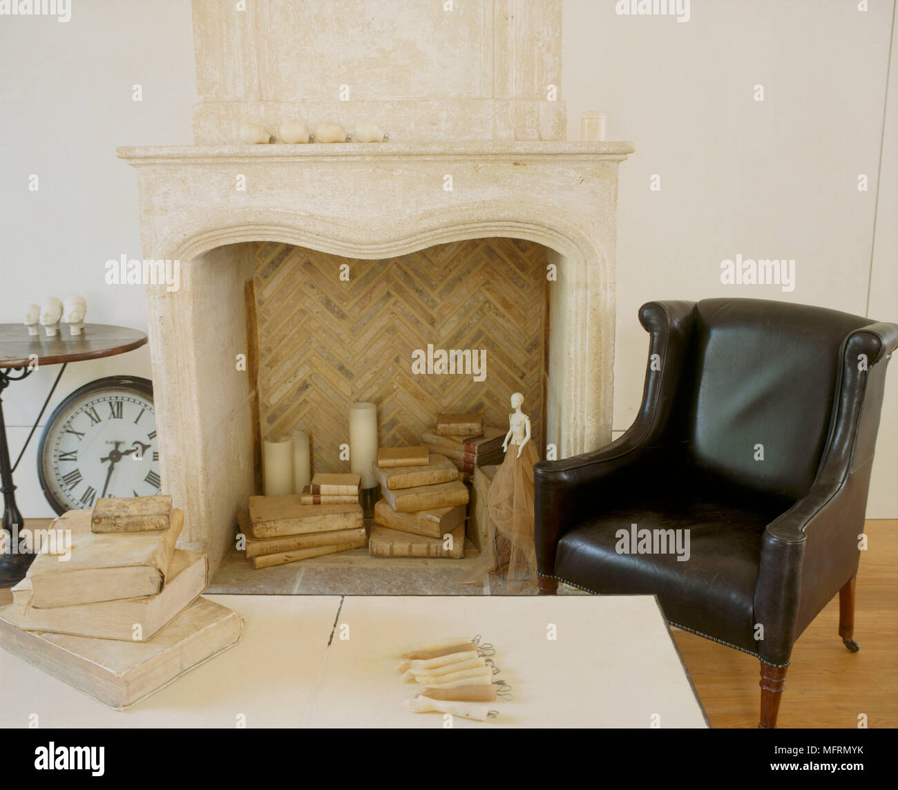 A detail of a traditional sitting room showing a stone fireplace with ...